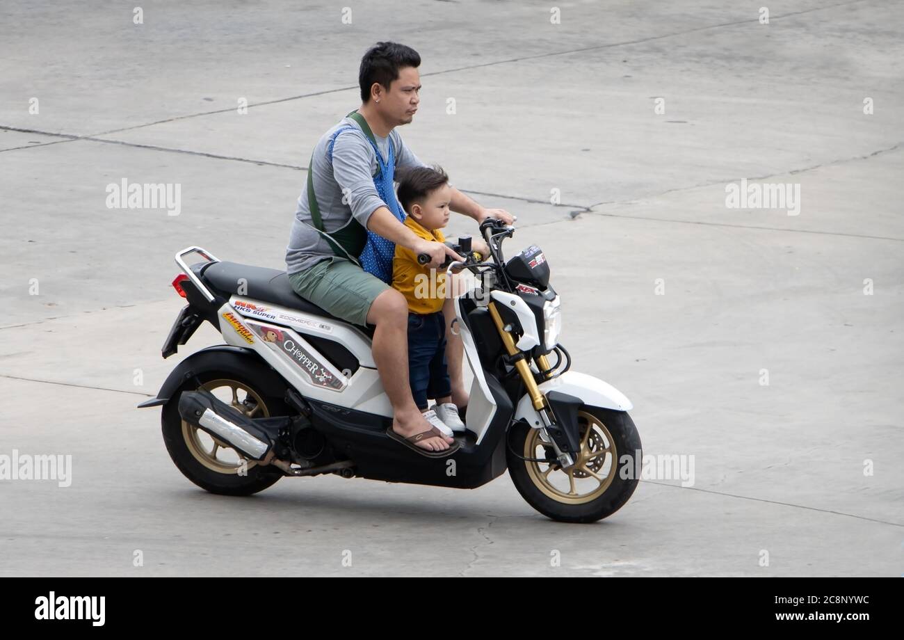 SAMUT PRAKAN, THAILAND, JUL 03 2020, The man rides on a motorcycle with ...