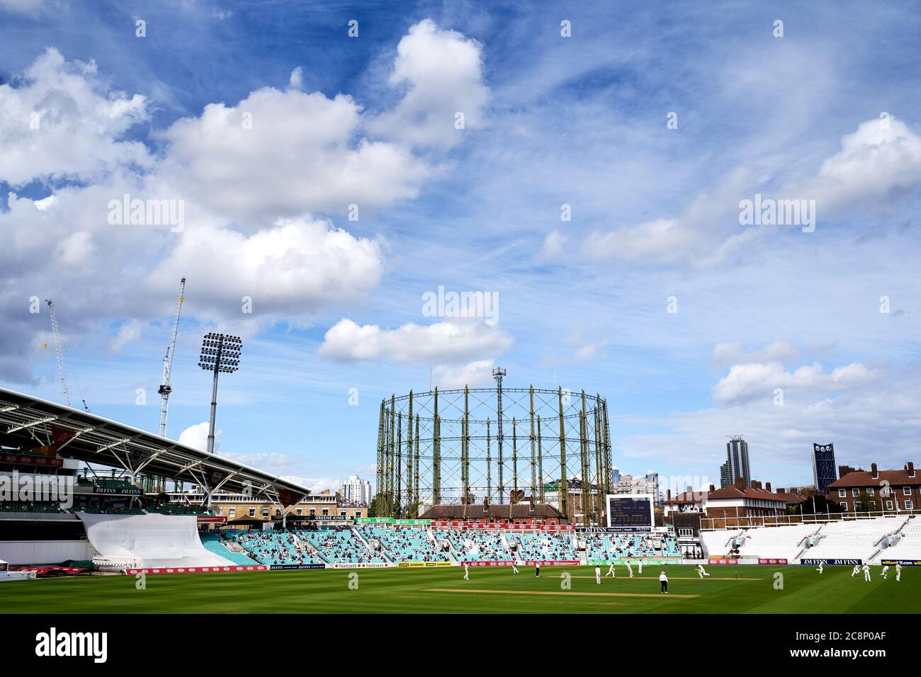 Spectators watch the action in front of the Oval Gasholders during the ...