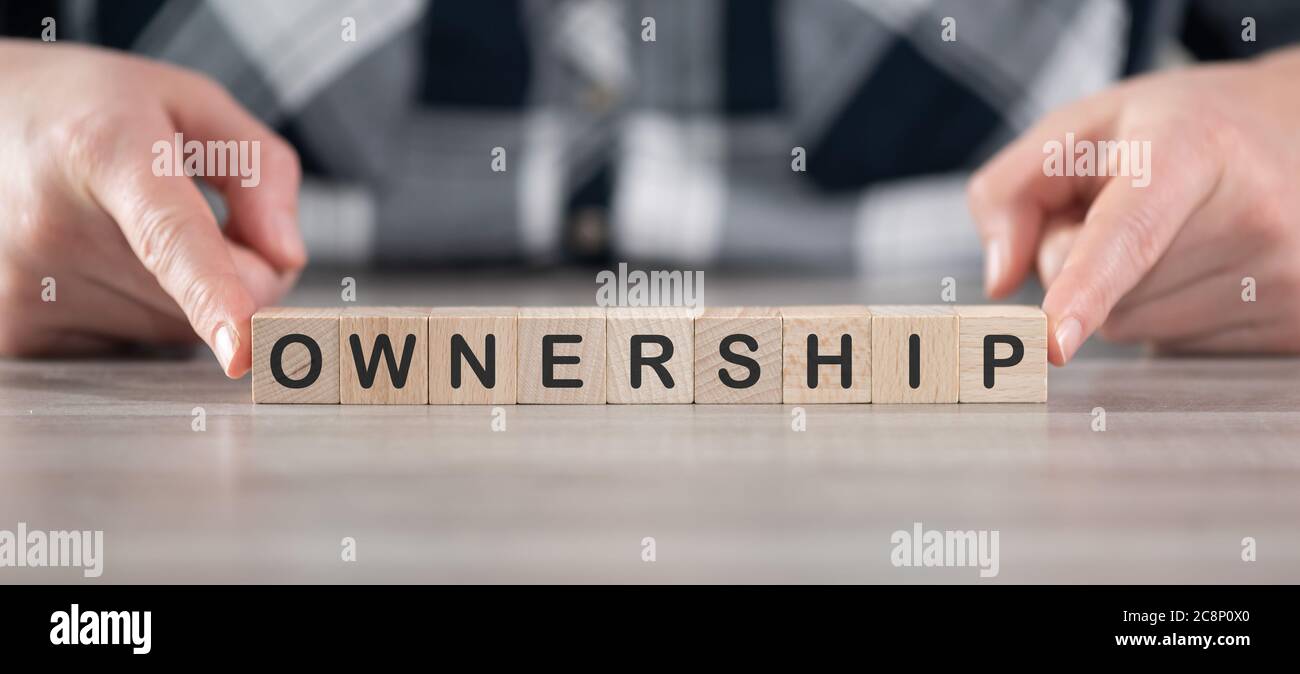 Concept of ownership on wooden cubes Stock Photo - Alamy