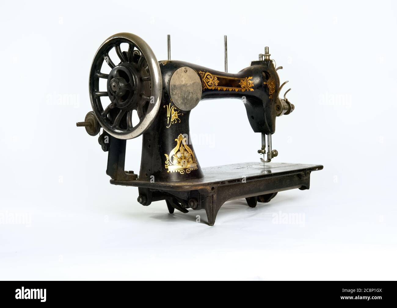 Old, historical sewing machine isolated against a white background ...