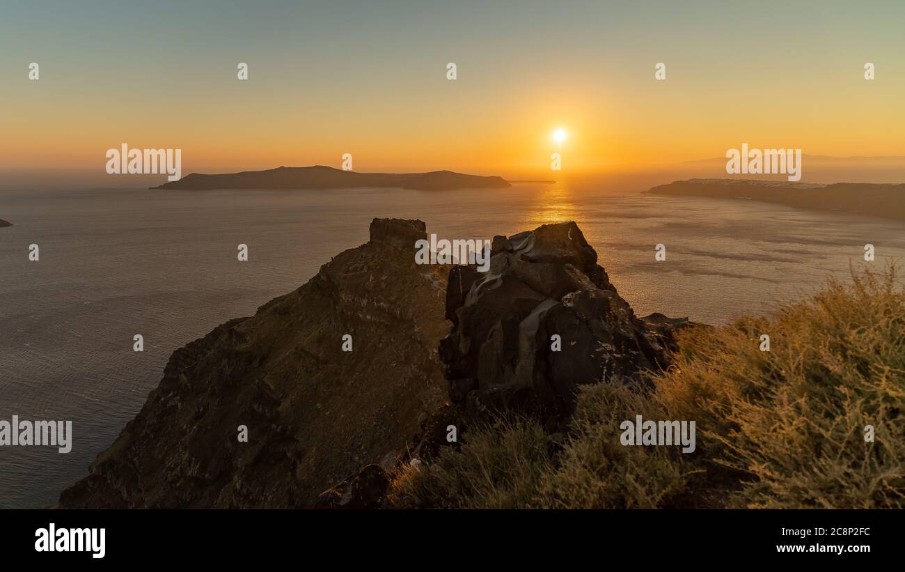 Beautiful sunset over Santorini volcano Stock Photo - Alamy