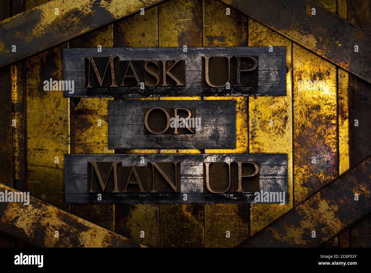 Mask Up or Man Up text formed with real authentic typeset letters on ...