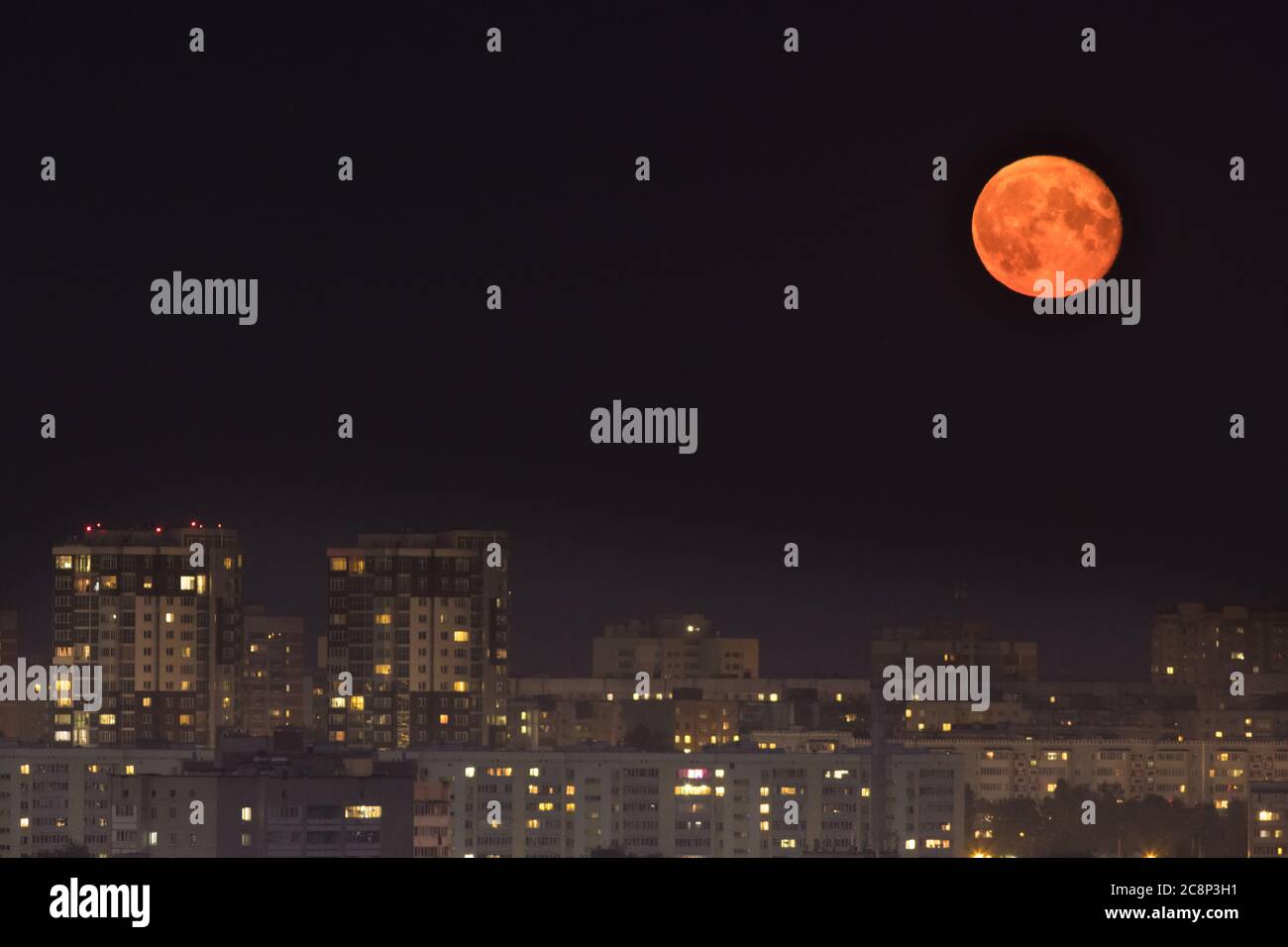 Bright yellow moon in dark night sky above the city. Background Stock ...