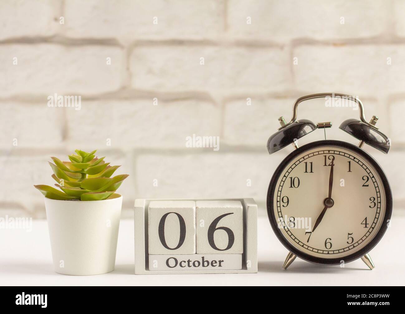 October 6 on the wooden calendar next to the alarm clock, the date of ...