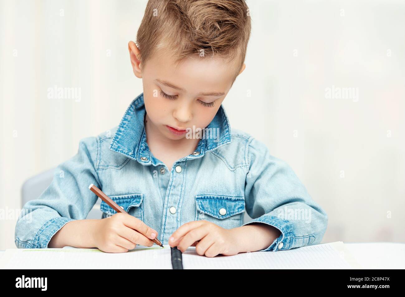 Portrait of child boy drawing with colorful pencils Stock Photo - Alamy