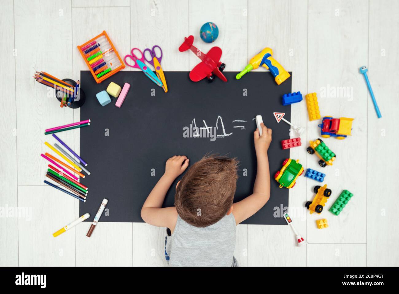Little boy learning to write numbers. Learning math Stock Photo - Alamy