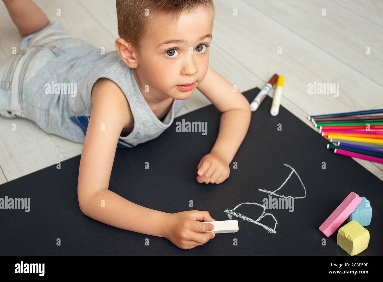 Baby boy studying at home. Happy child on the floor learns the alphabet ...