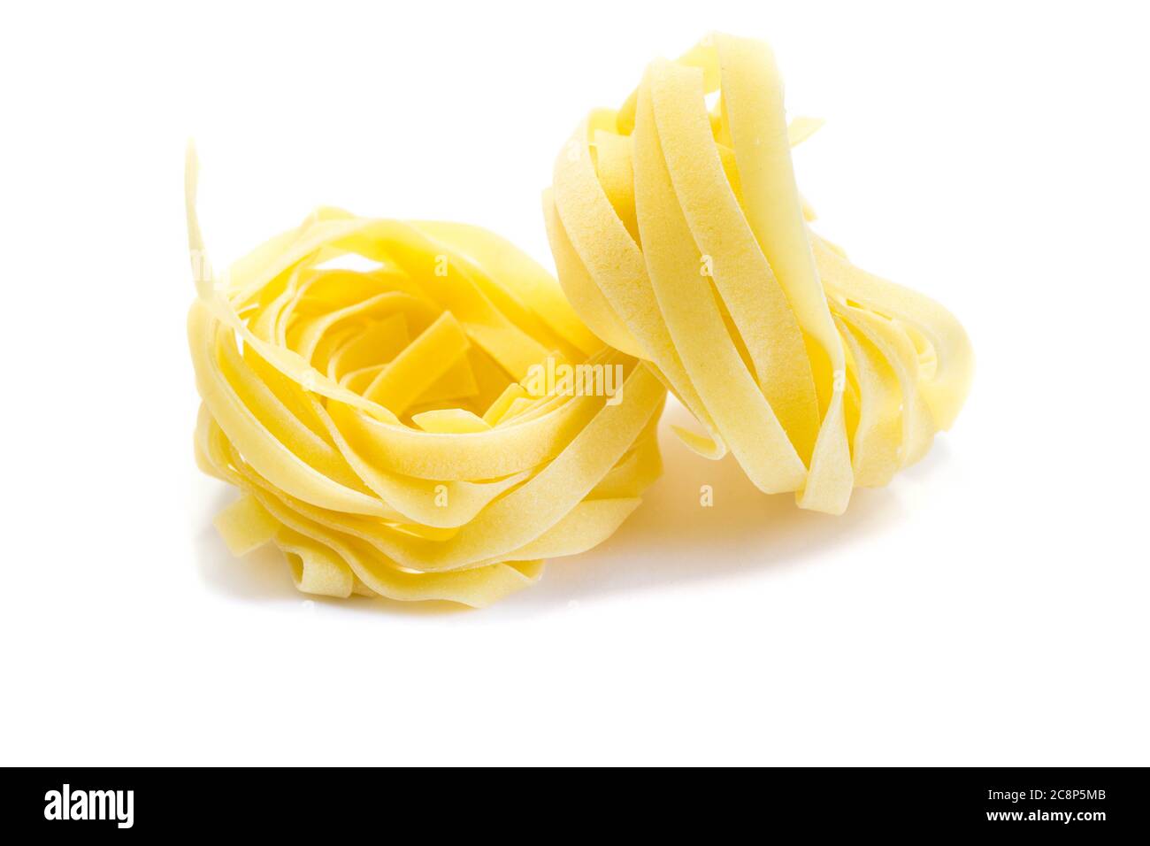 Ribbon pasta isolated on white background Stock Photo - Alamy