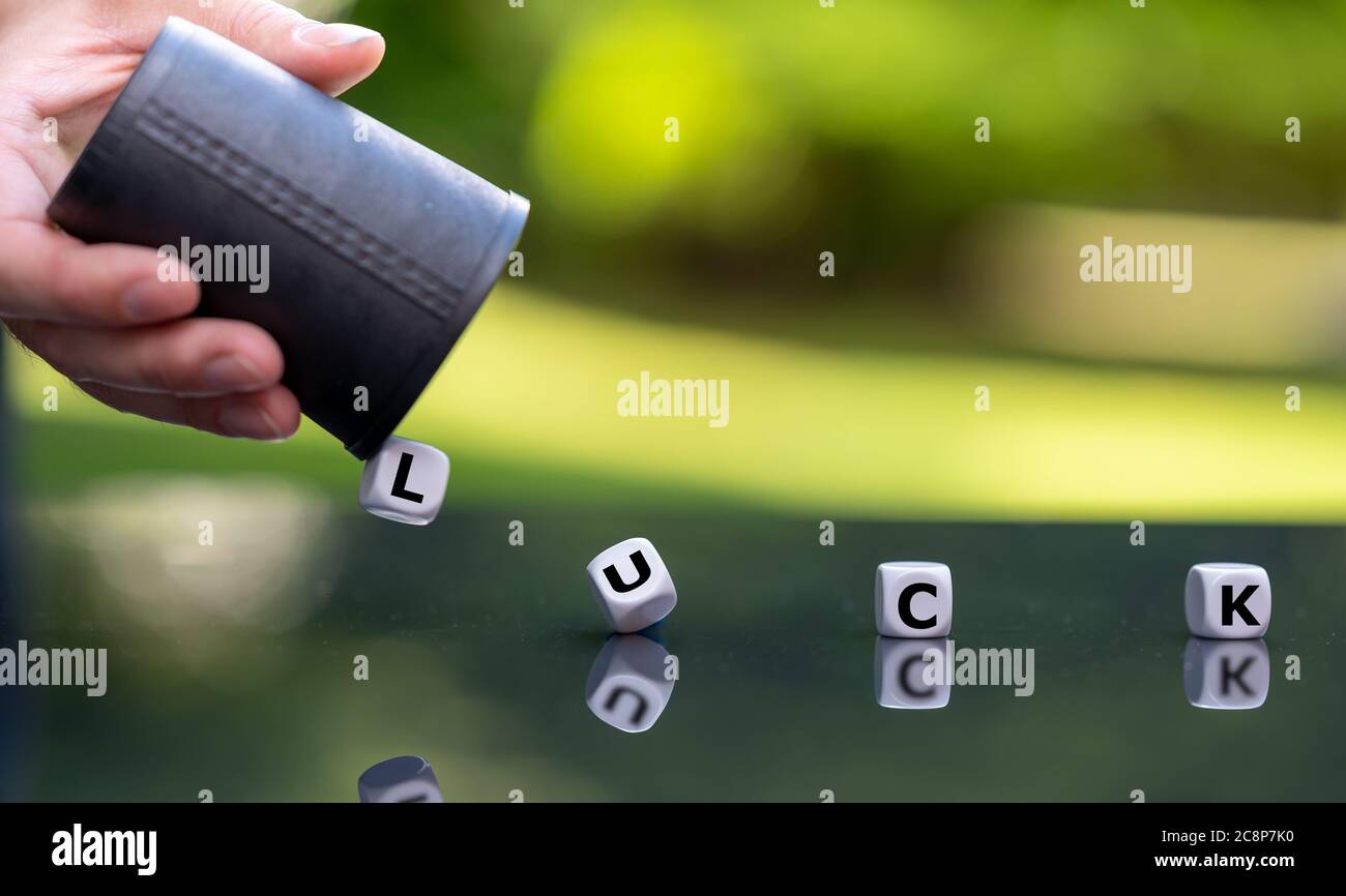 Symbol for having luck. Hand rolls the dice which form the word "luck ...