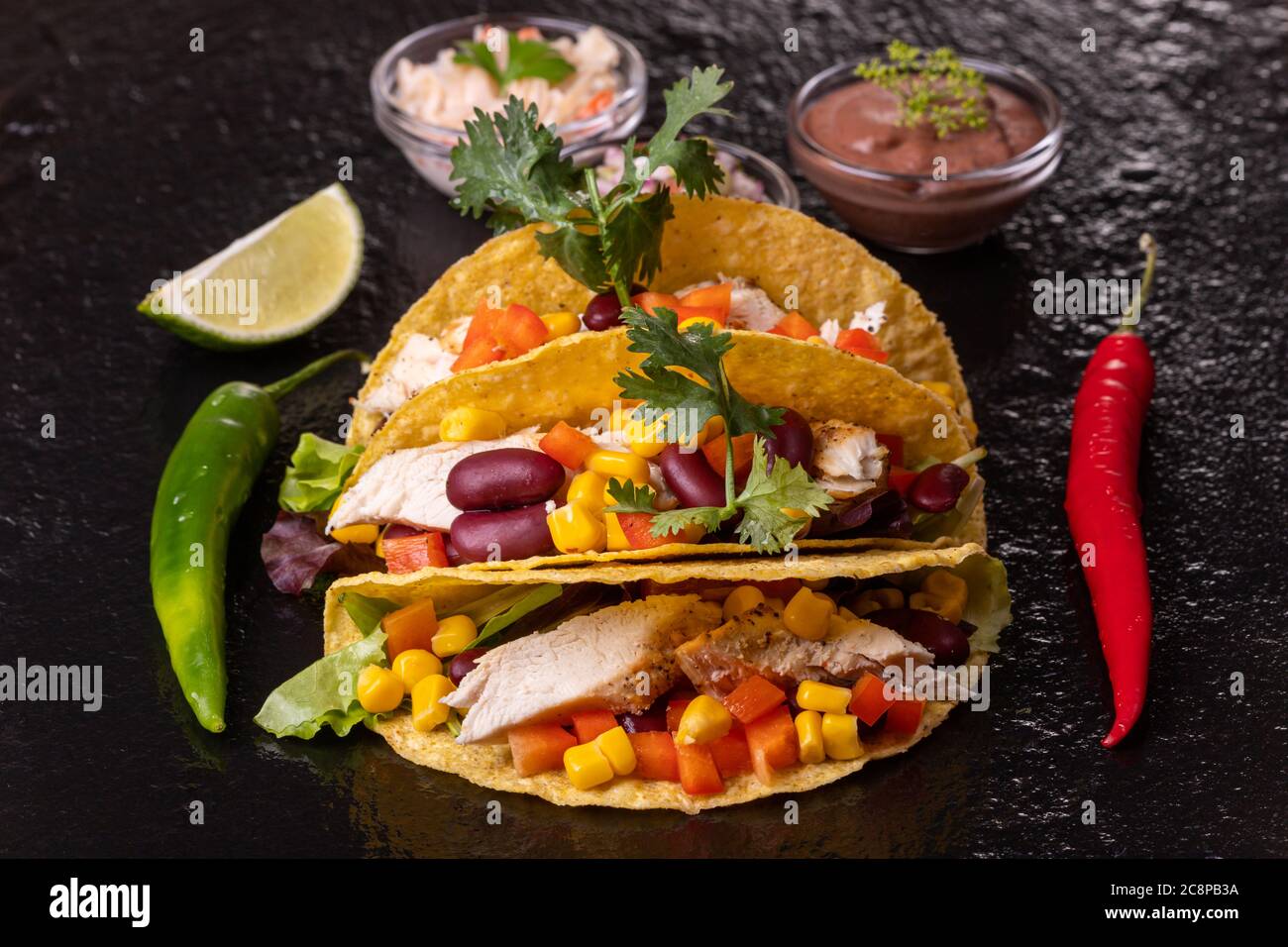 three mexican tacos on slate Stock Photo - Alamy