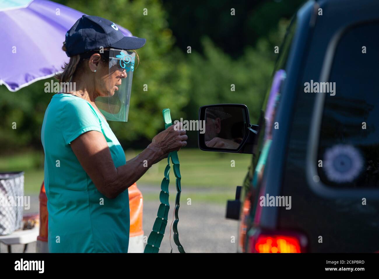 July 25, 2020: 50/50 raffle tickets are sold to drive in guests while ...