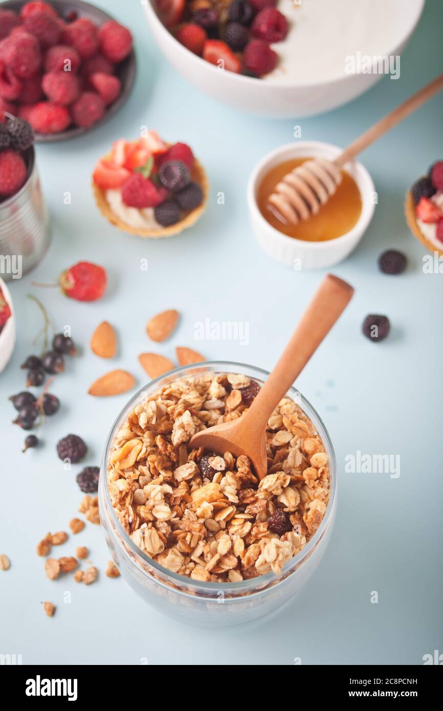 Healthy oat granola muesli cereals in a jar with fresh berries, nuts ...