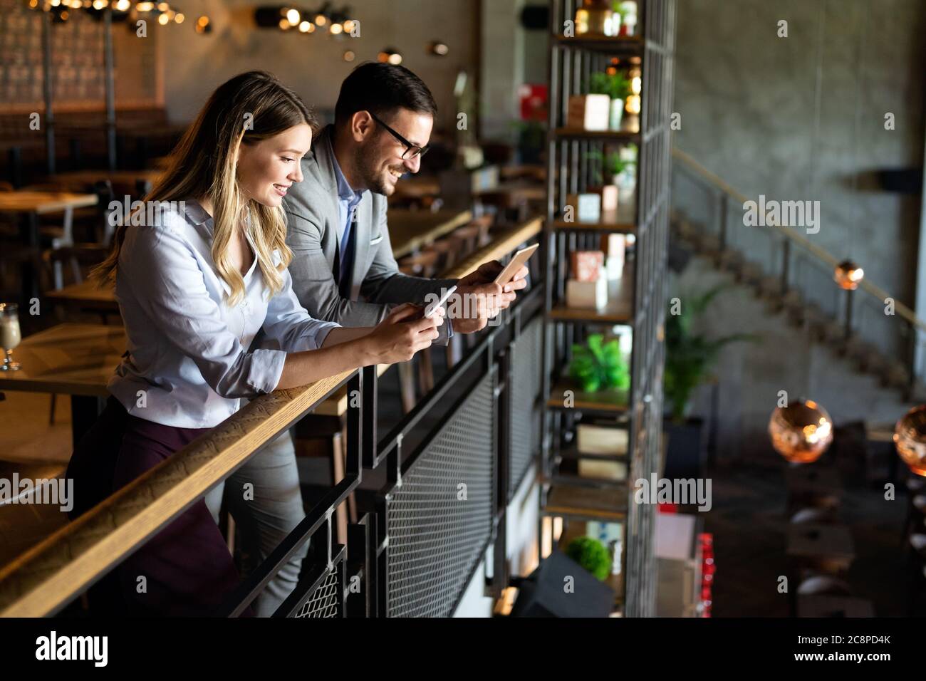 Cheerful coworkers in office working and brainstorming together Stock ...