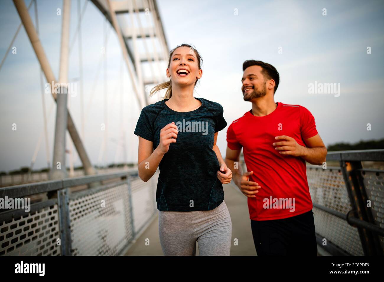 Beautiful couple running in nature living healthy Stock Photo - Alamy
