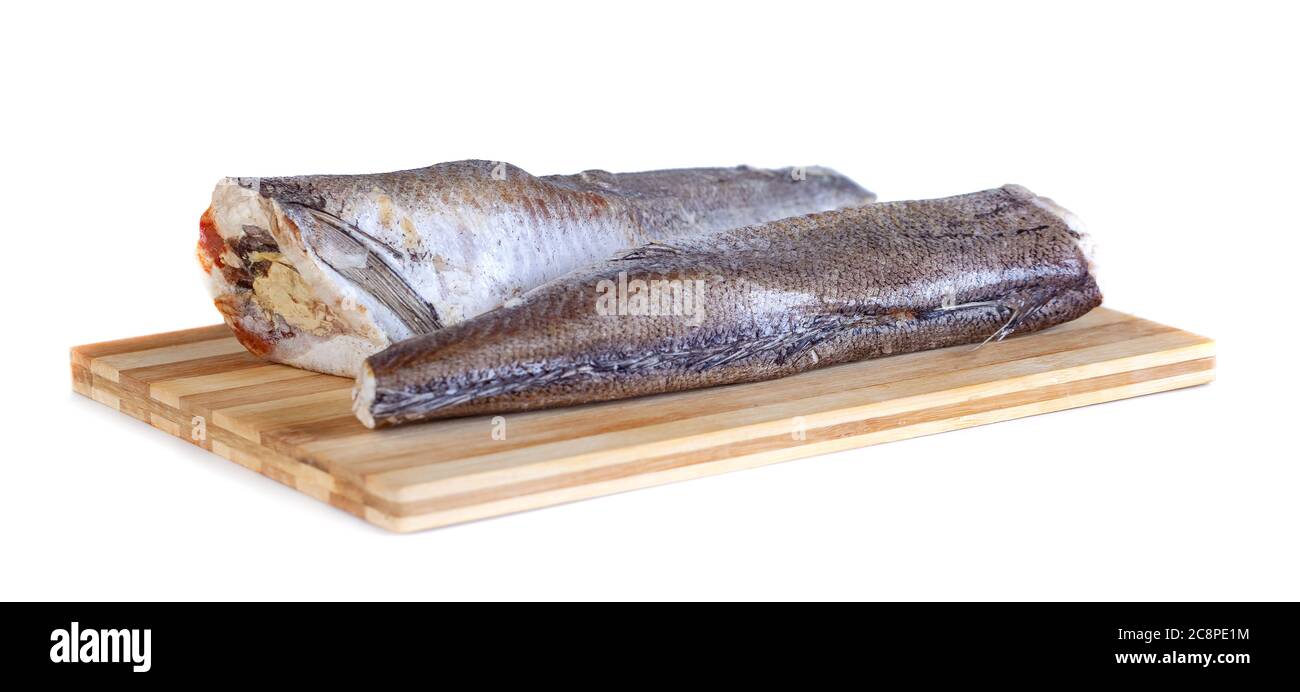 Frozen fish hake on the wooden board isolation on white Stock Photo - Alamy