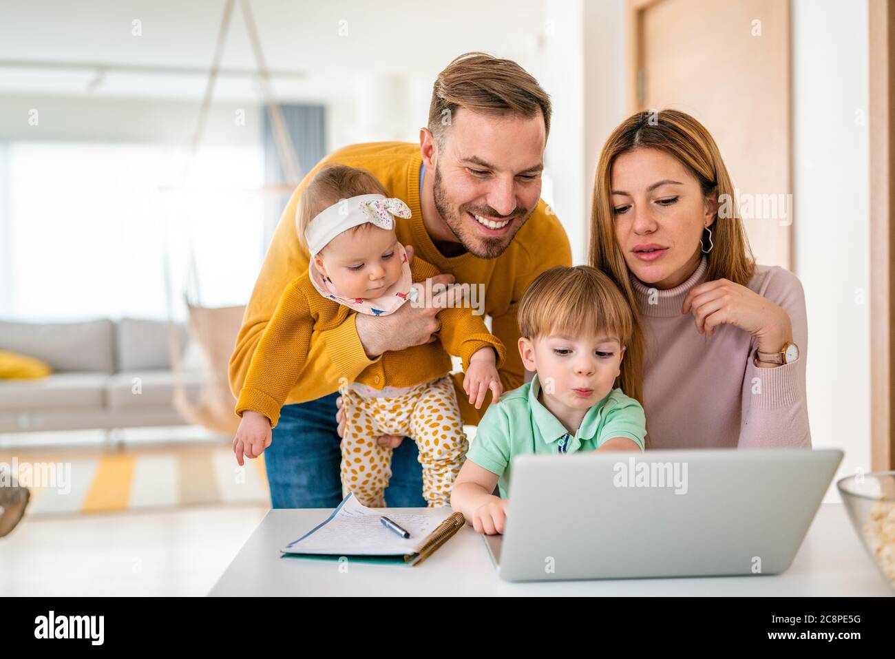 Happy smiling family chatting with computer together at home Stock ...