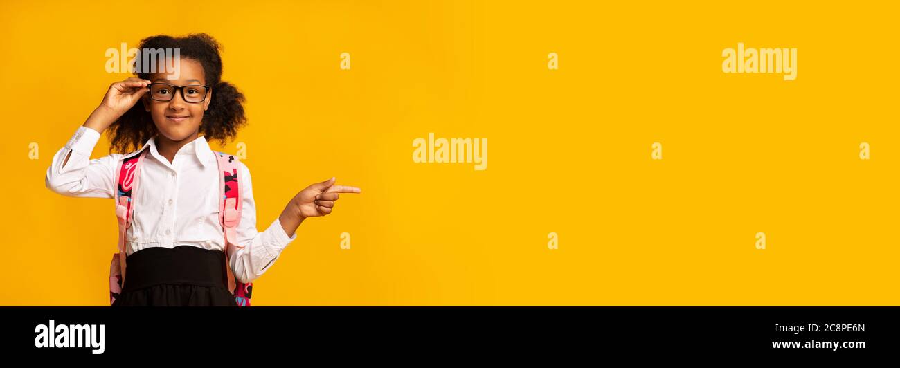 Adorable Black Schoolgirl Pointing Finger Aside, Studio, Panorama Stock ...