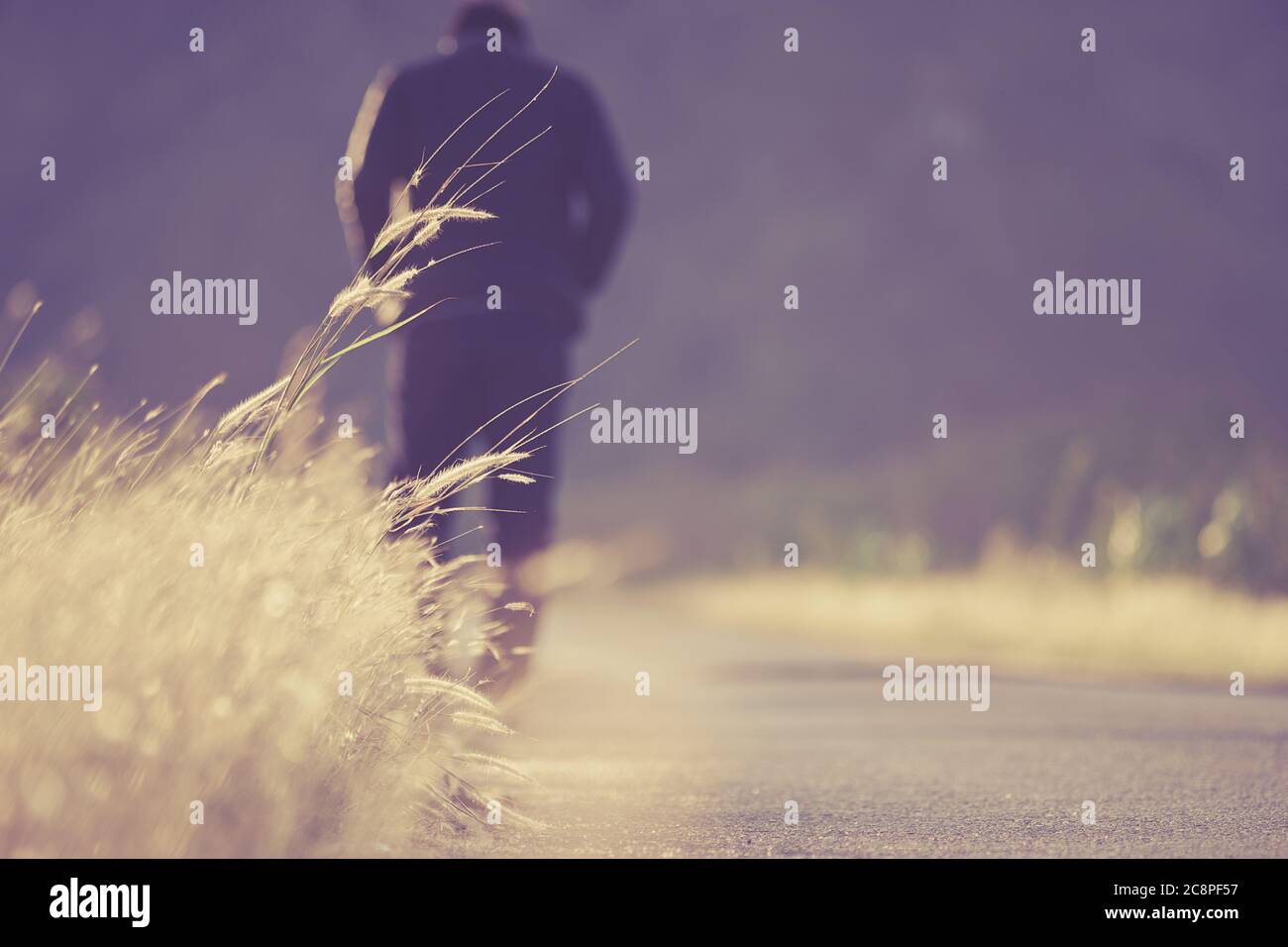 Alone Man walking on the road with sadness.Solf focus for background ...