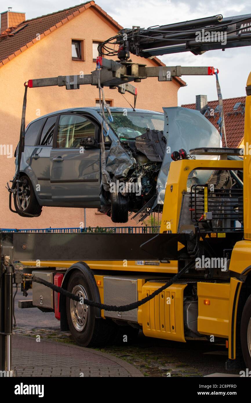 Dresden, Germany. 26th July, 2020. A tow truck lifts a damaged car onto ...