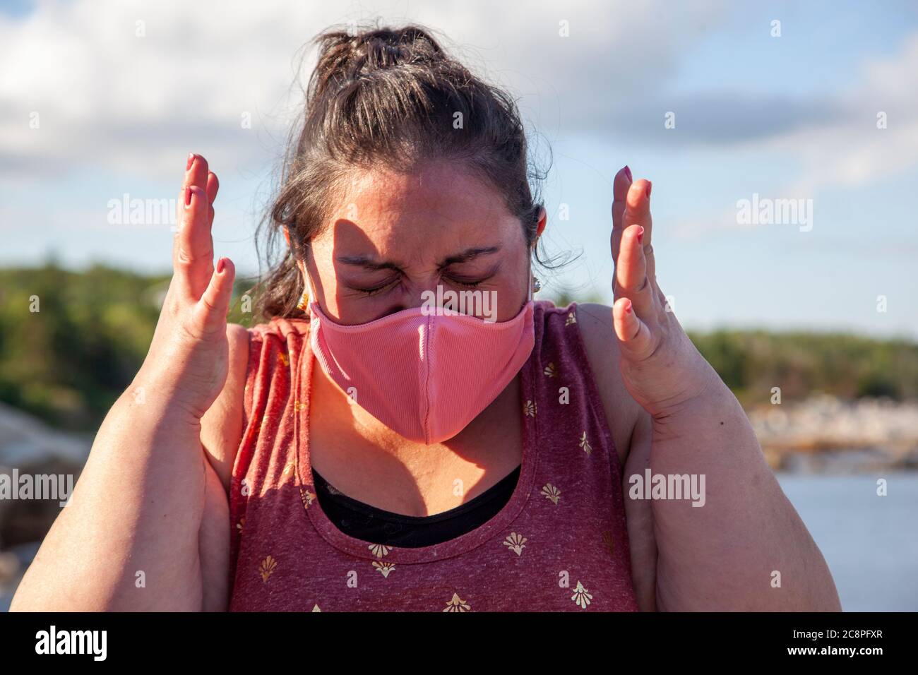 woman hates wearing her pandemic face mask is yelling or crying with ...