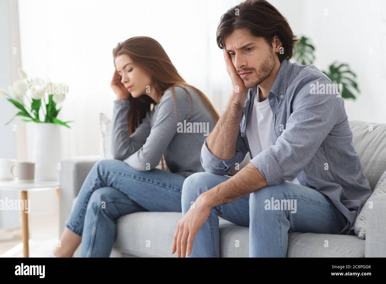 Sad married couple avoiding each other, home interior Stock Photo - Alamy