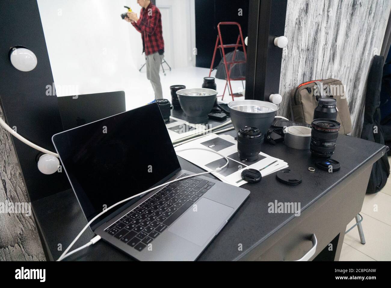 Digital camera, lens and laptop. concept of photographer work station ...