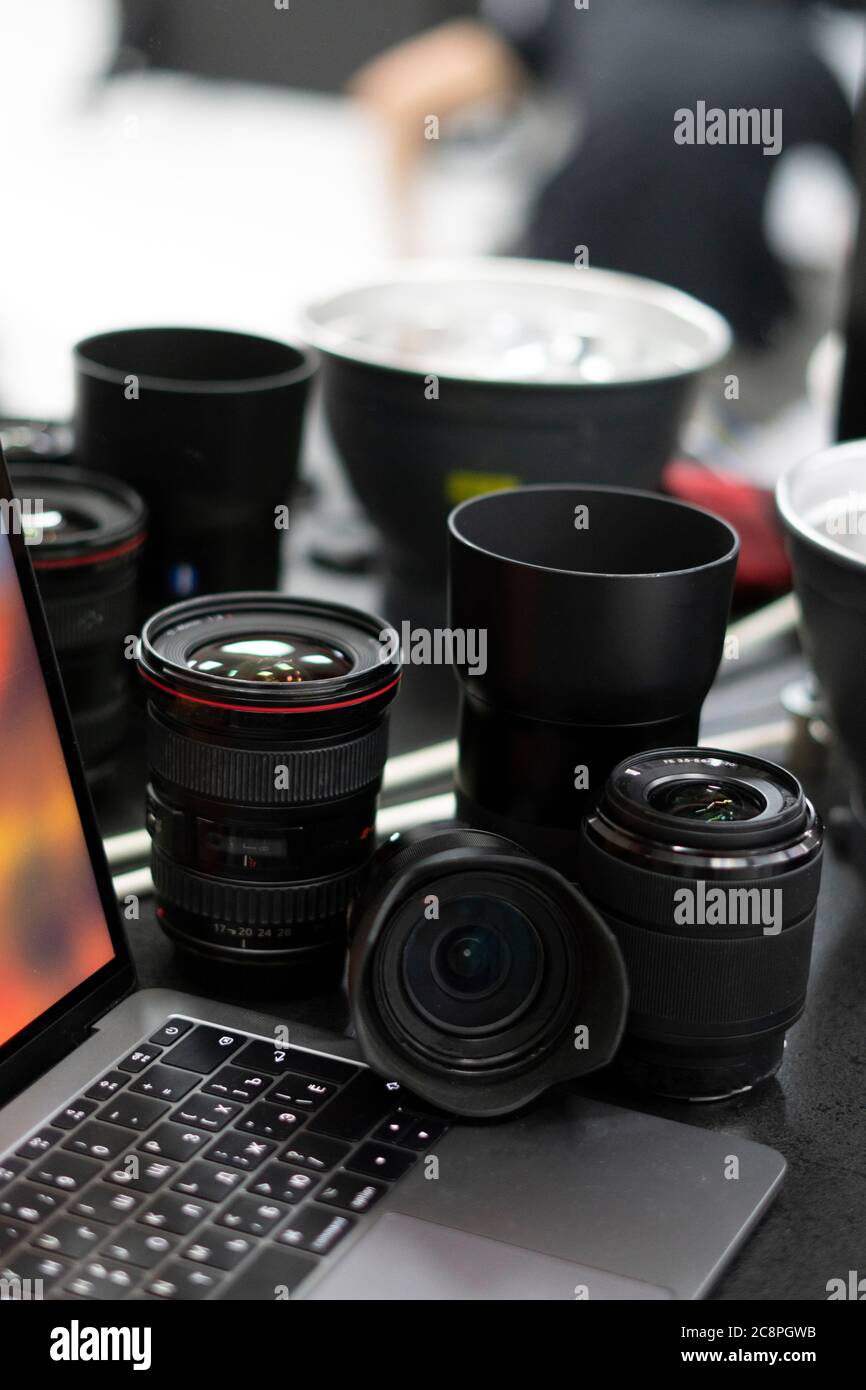 Digital camera, lens and laptop. concept of photographer work station ...