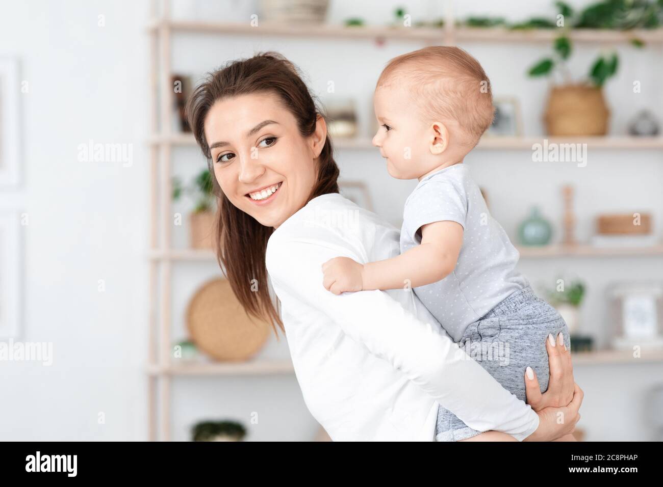 Mother Baby Activities. Happy Young Mom Playing With Baby Son At Home ...