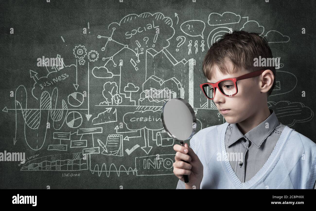 Curious school boy with magnifier Stock Photo - Alamy