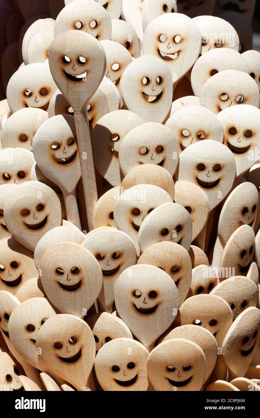 Close up handmade rustic wooden cooking spoons with carved happy ...