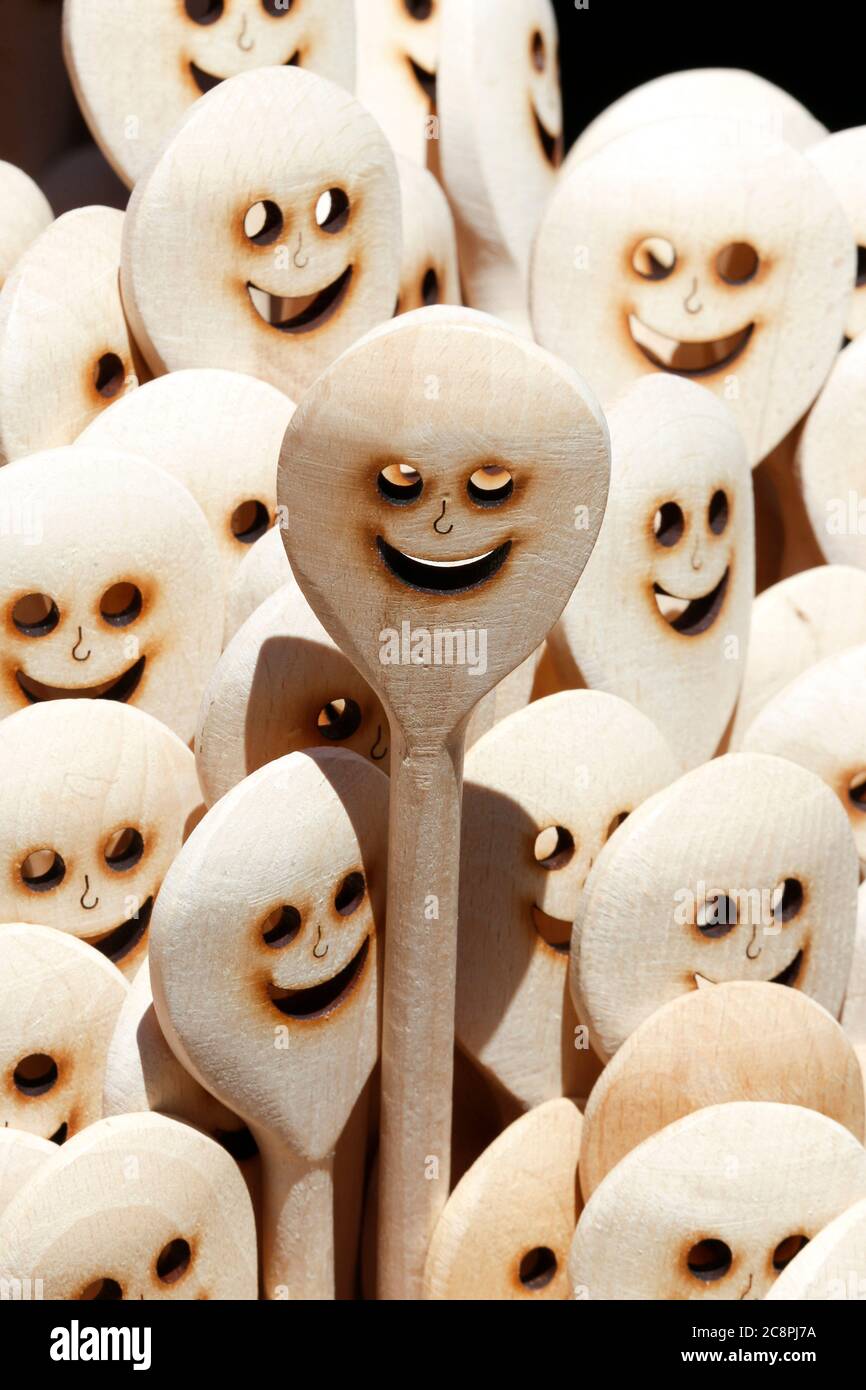 Close up handmade rustic wooden cooking spoons with carved happy ...