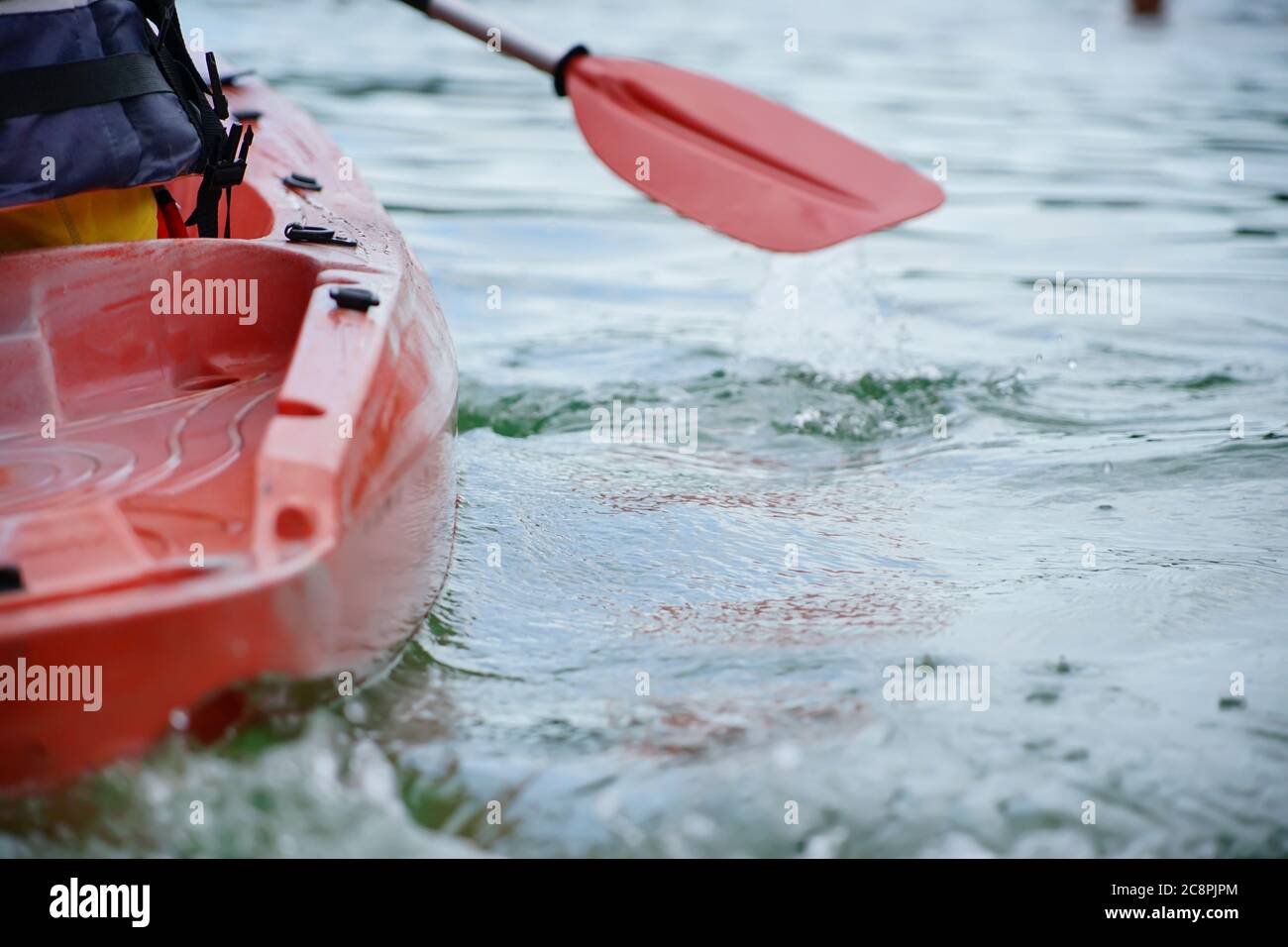 Red kayak floats on water, rear side view Stock Photo - Alamy