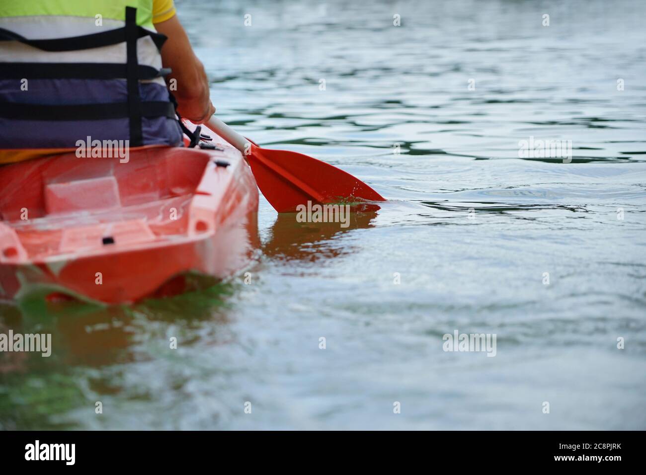 Red kayak floats on water, rear side view Stock Photo - Alamy