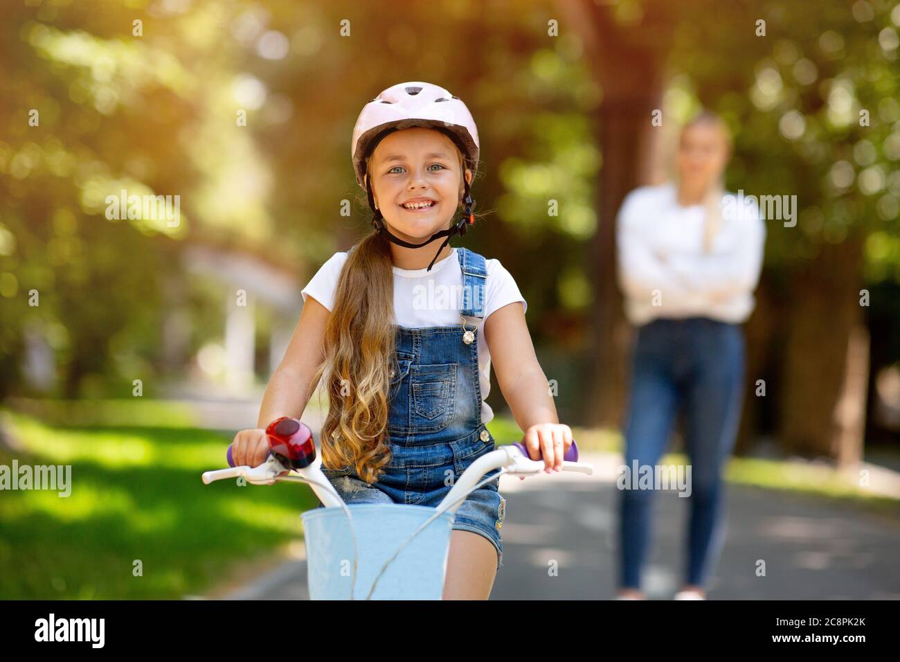 Little Daughter Riding Bicycle Spending Weekend With Mother In Park ...