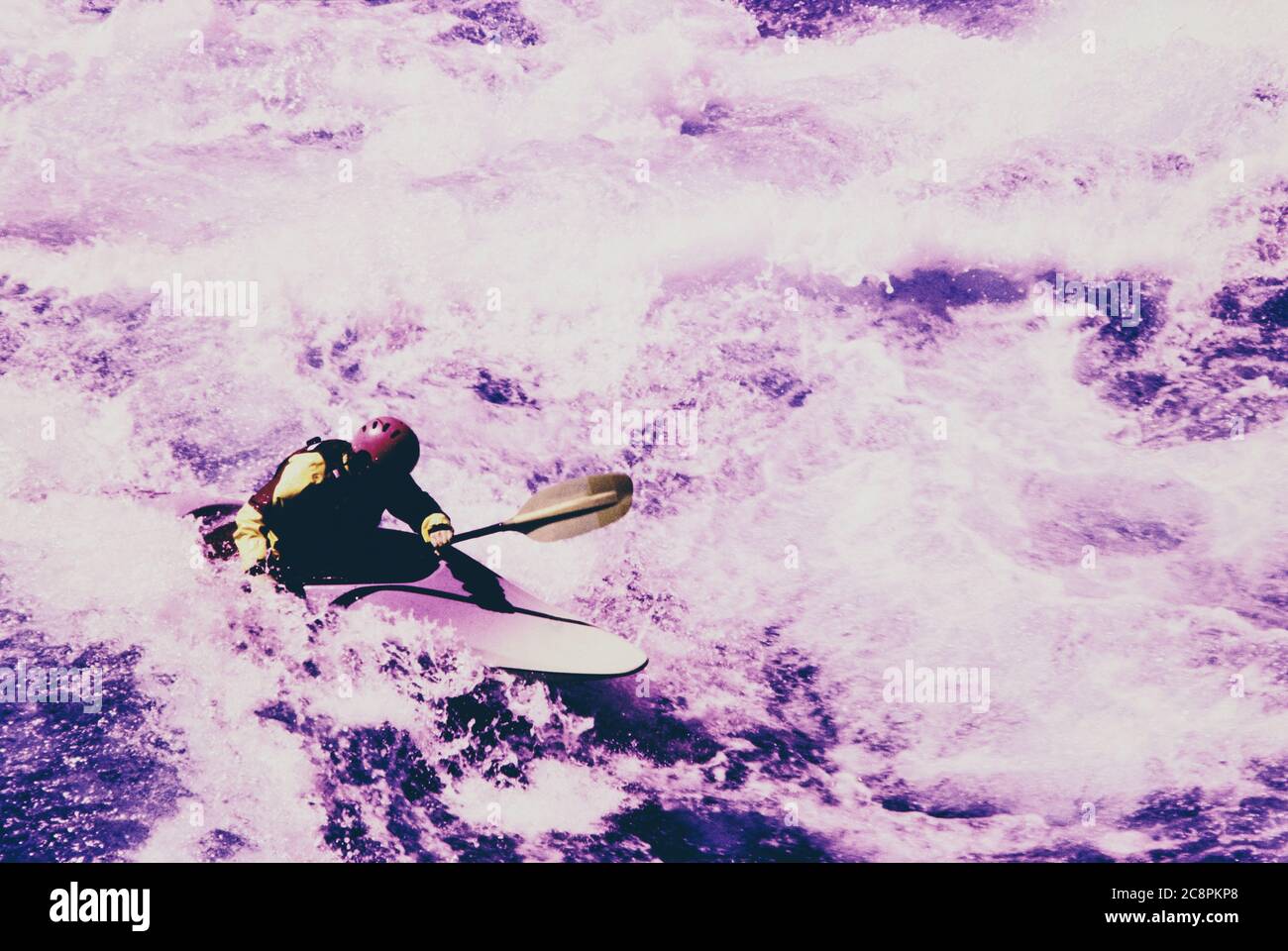 Color infrared image of white kayaker paddling river rapids on a fast ...