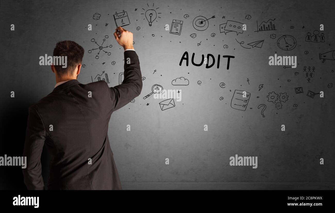 businessman drawing a creative idea sketch with AUDIT inscription ...
