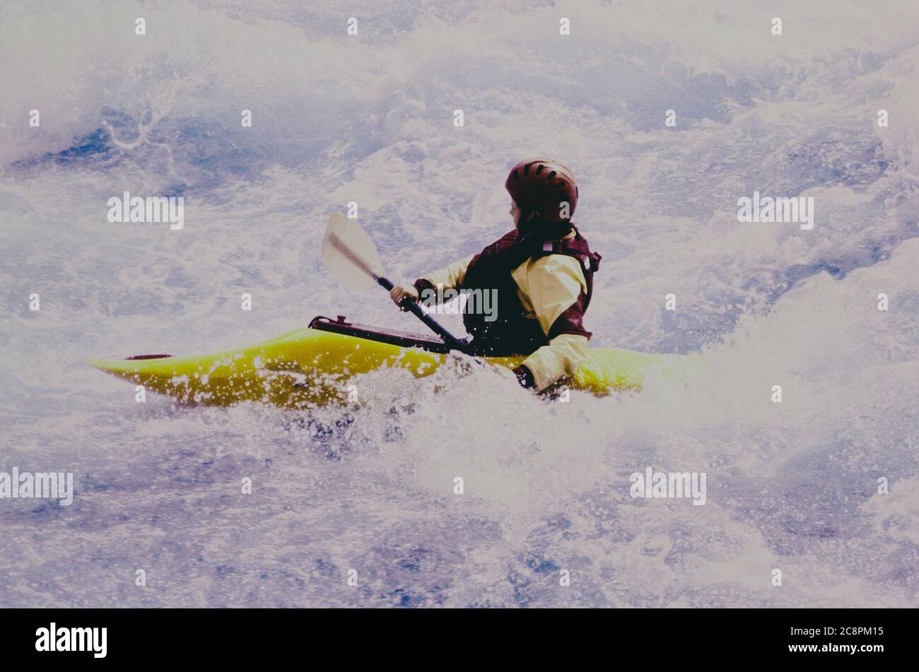 Color infrared image of white kayaker paddling river rapids on a fast ...