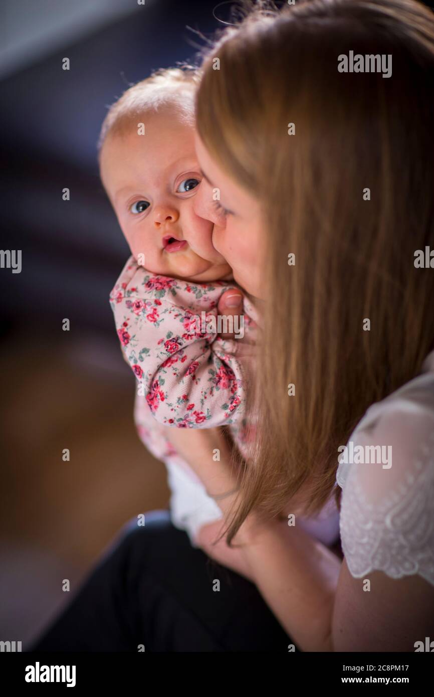 Baby on cheek hi-res stock photography and images - Alamy