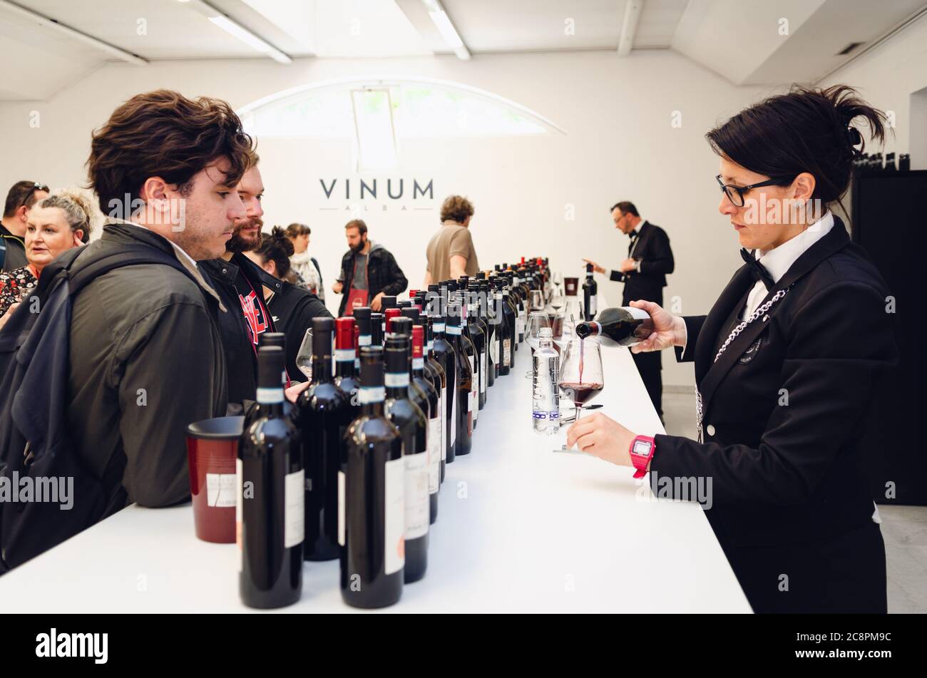 ALBA, ITALY - APRIL 25, 2019 – Female sommelier and man tasting ...