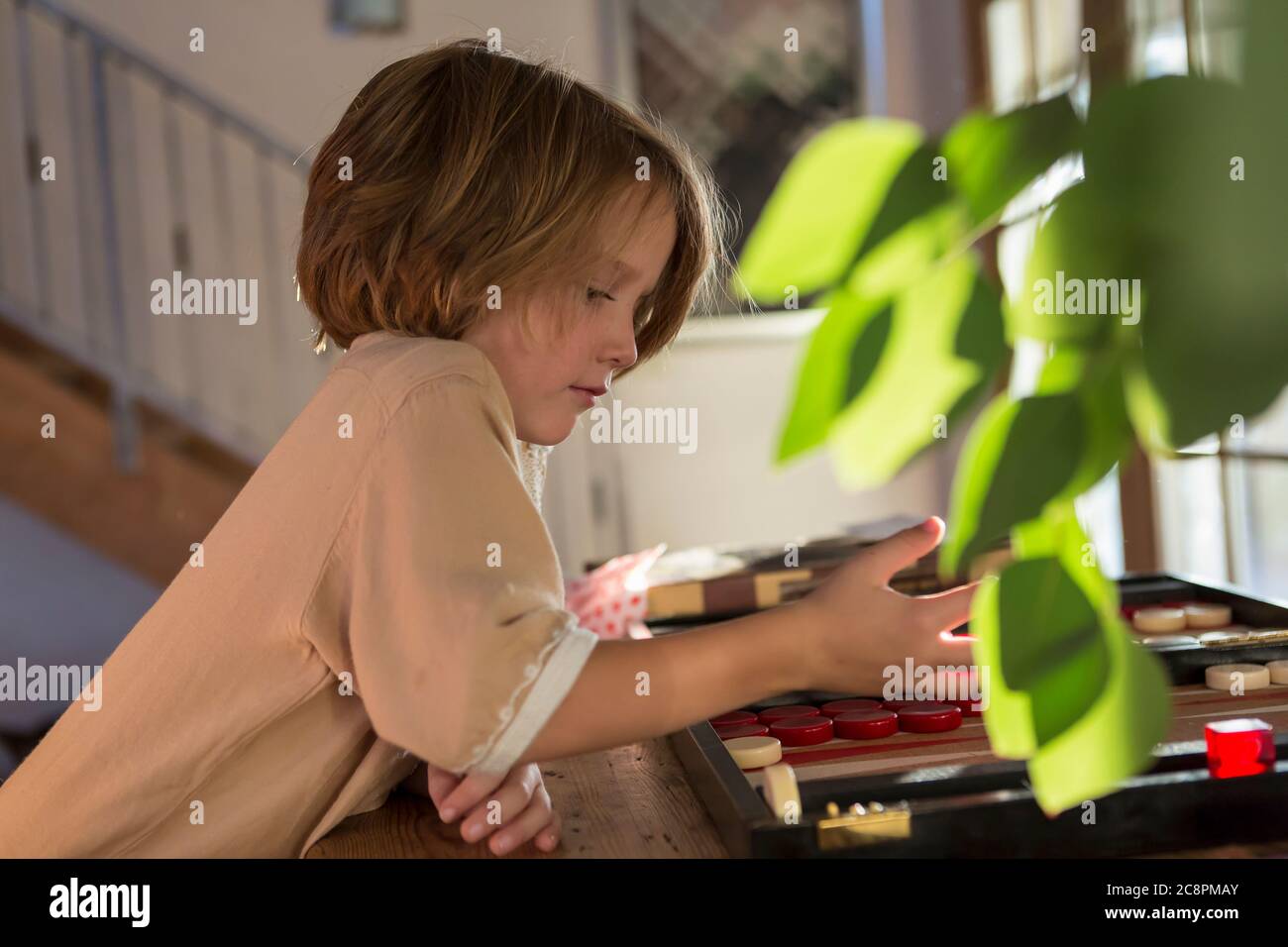 4 year old boy playing board game at home Stock Photo - Alamy