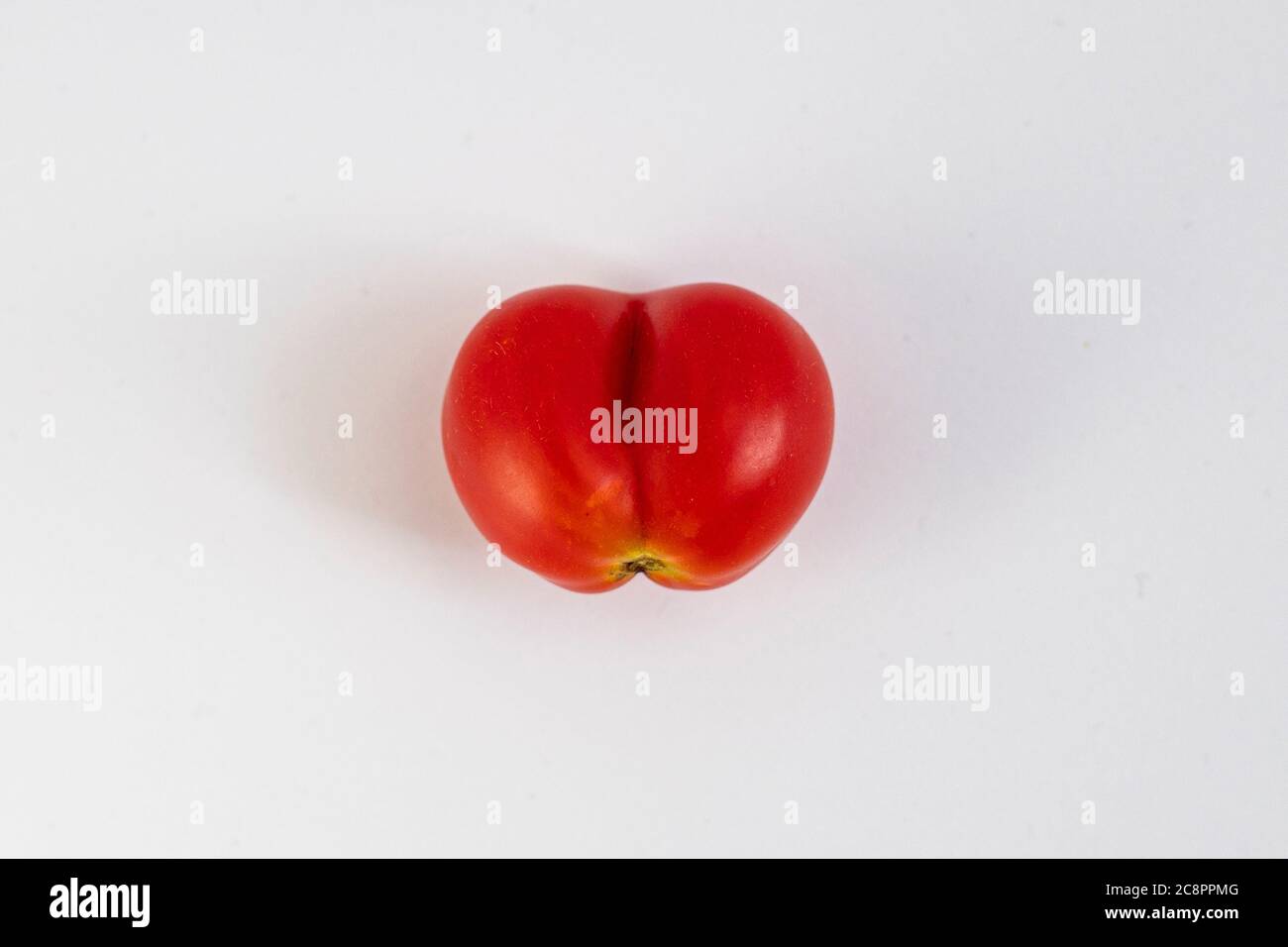 Human bottom shaped tomato, isolated on white background, still life ...