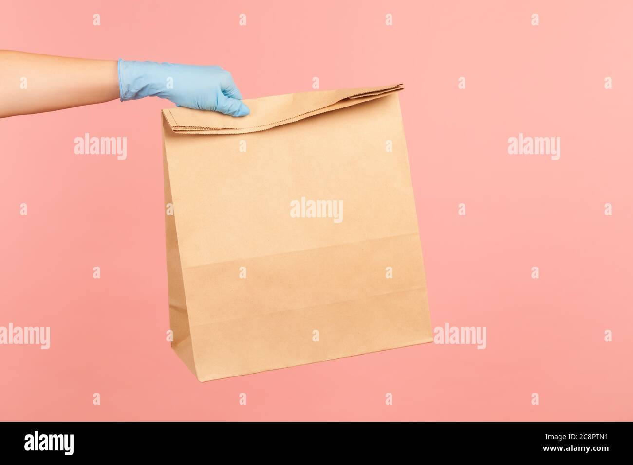Profile side view closeup of human hand in blue surgical gloves holding ...