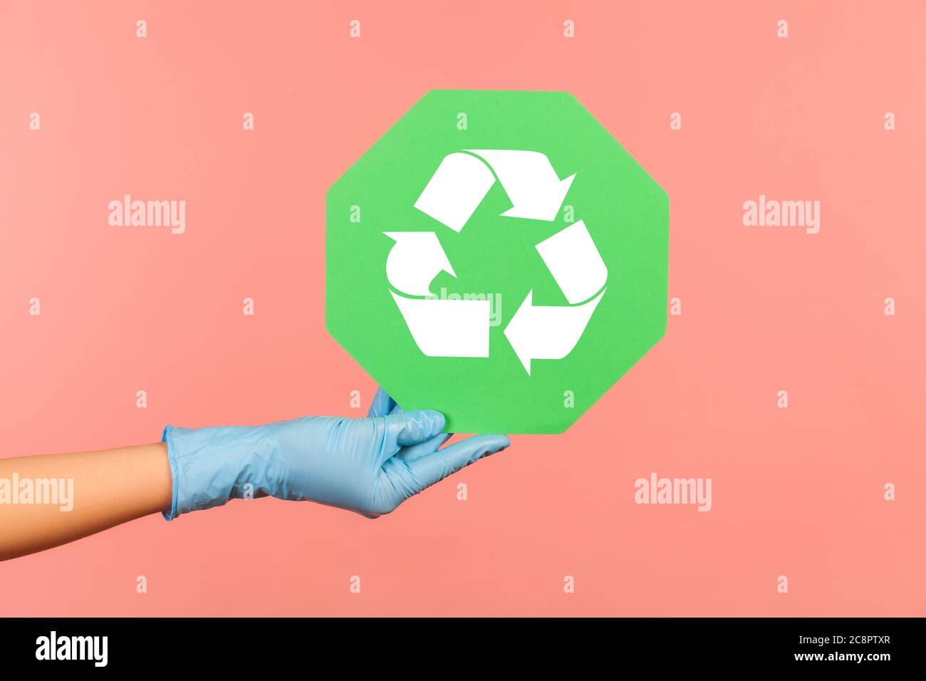 Profile side view closeup of human hand in blue surgical gloves holding ...