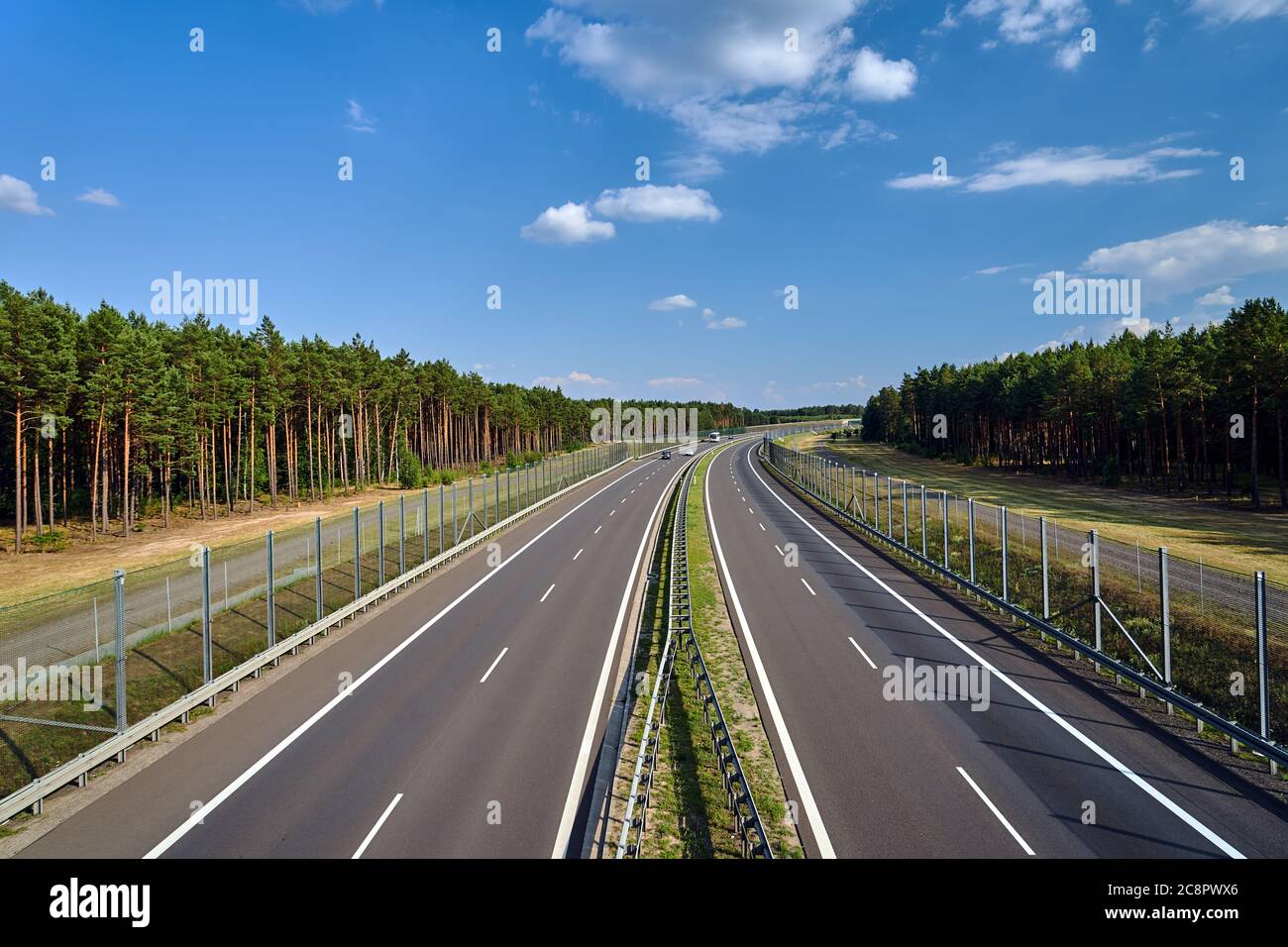 A two-lane asphalt expressway crossing the forest in Poland Stock Photo ...