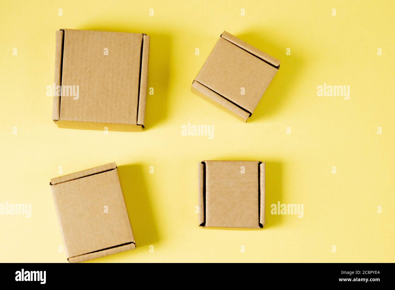Cardboard boxes of various sizes on yellow background Stock Photo - Alamy