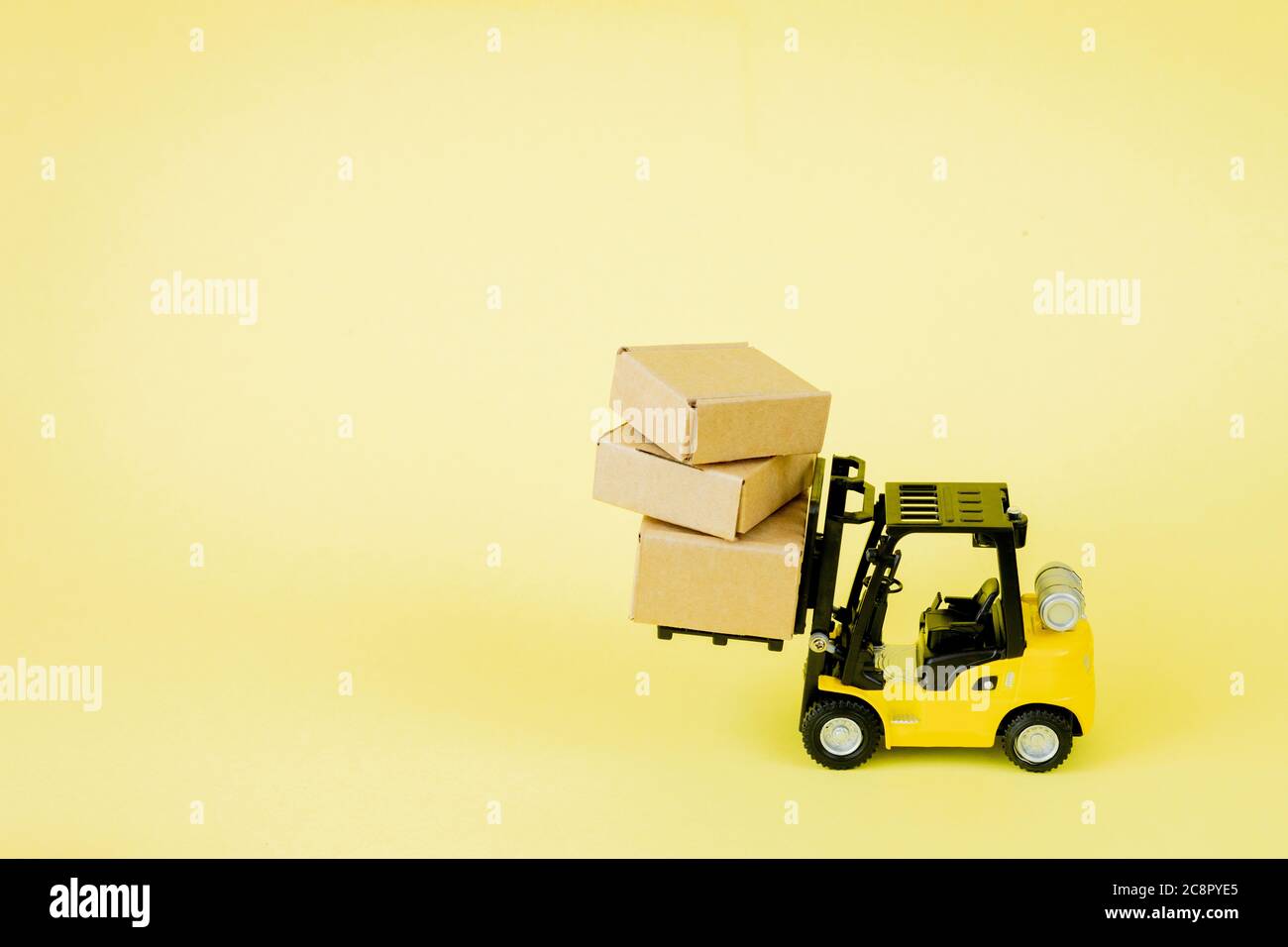 Mini forklift truck load cardboard boxes. Logistics and transportation ...