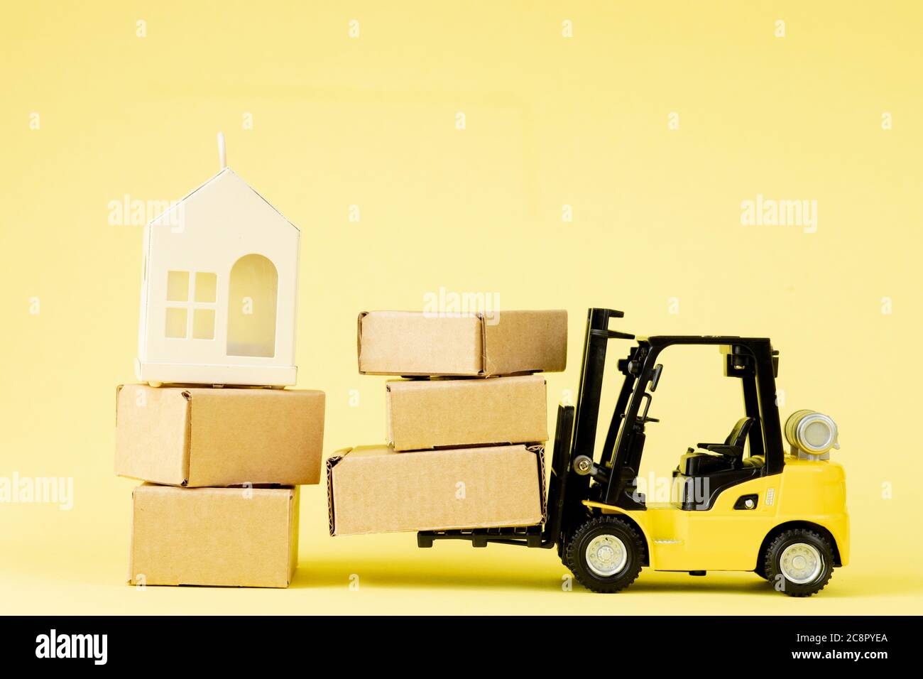 Mini forklift truck load cardboard boxes. Logistics and transportation ...