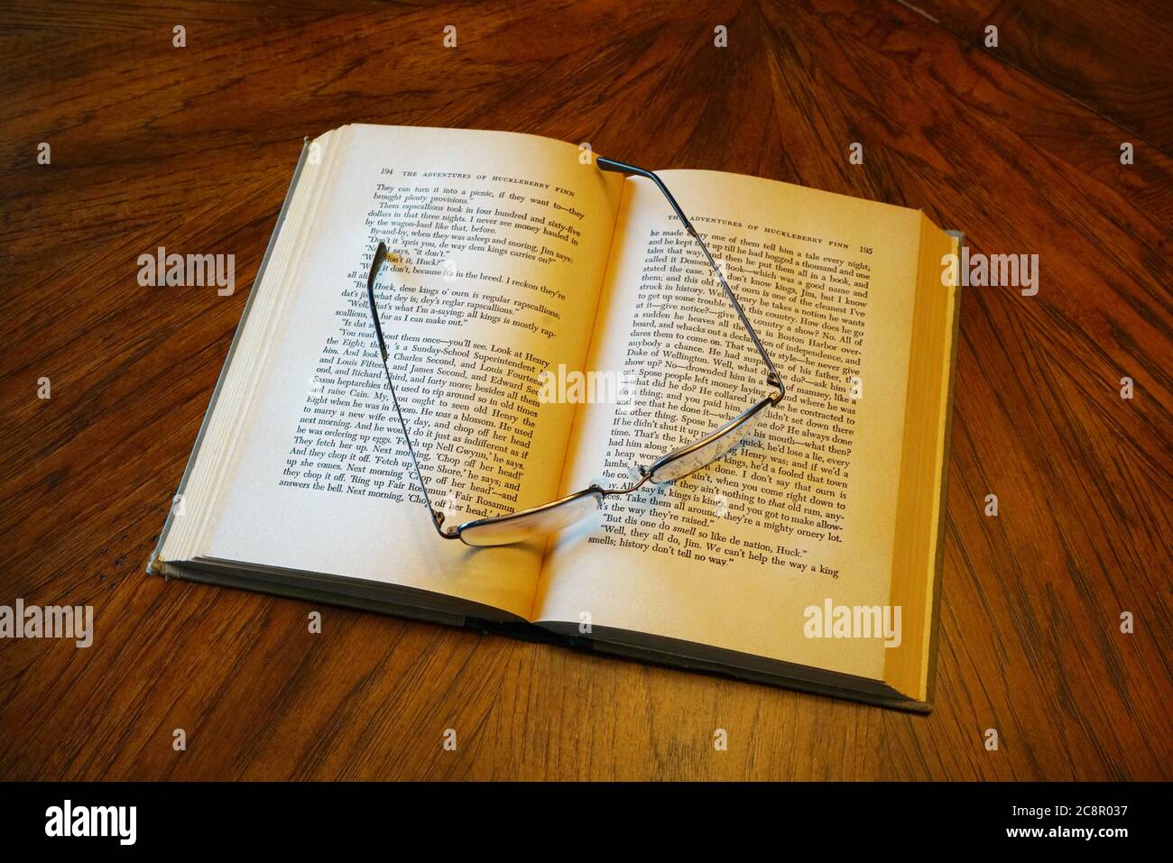 Vintage Book with reading glasses on wood table Stock Photo - Alamy