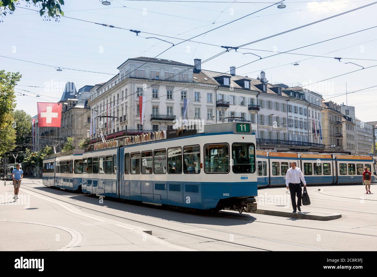 Zurich, Switzerland - 1 August, 2019: public transport and passers-by ...