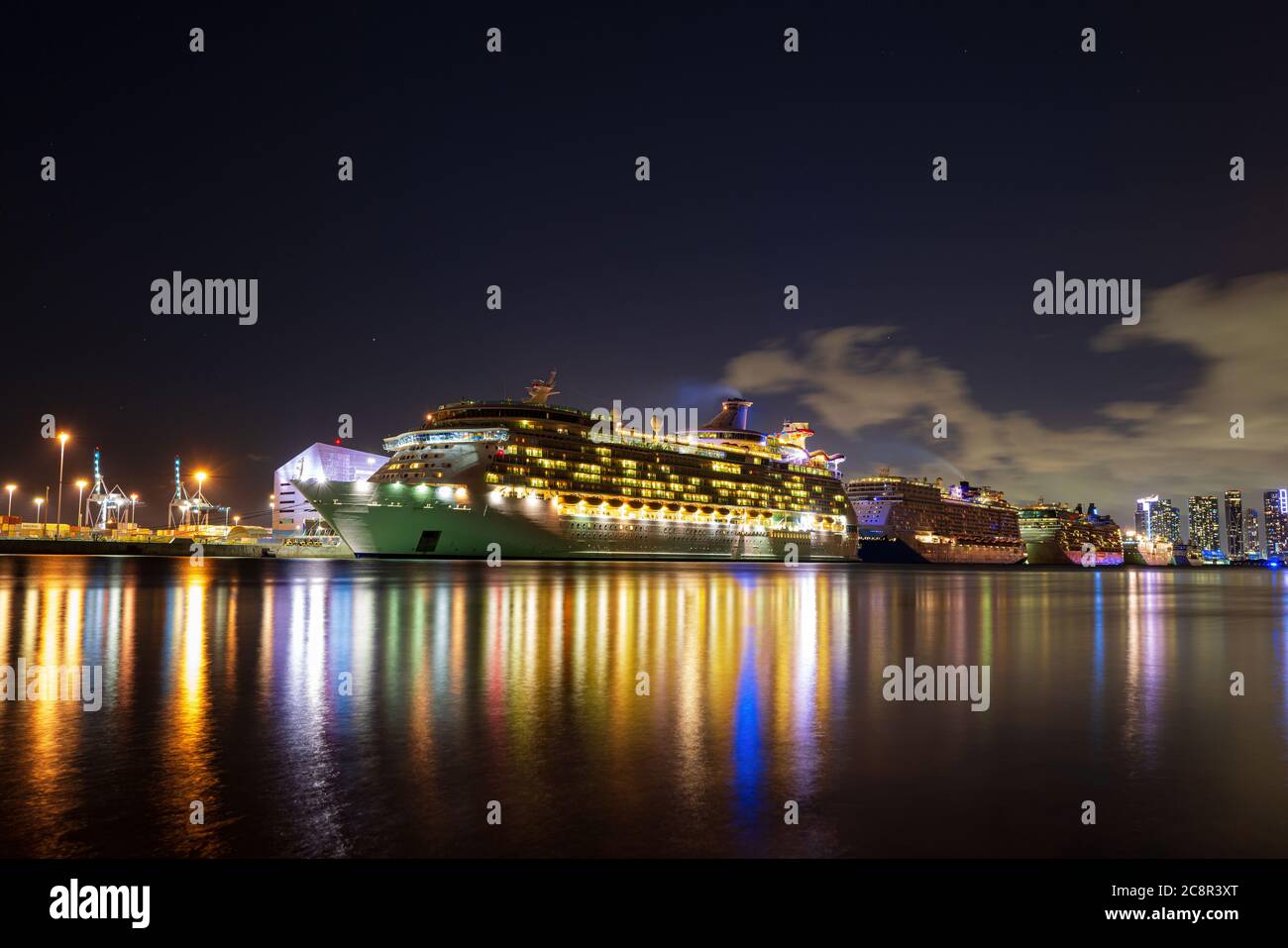 Cruise ship in the Port of Miami at sunset with multiple luxury yachts ...